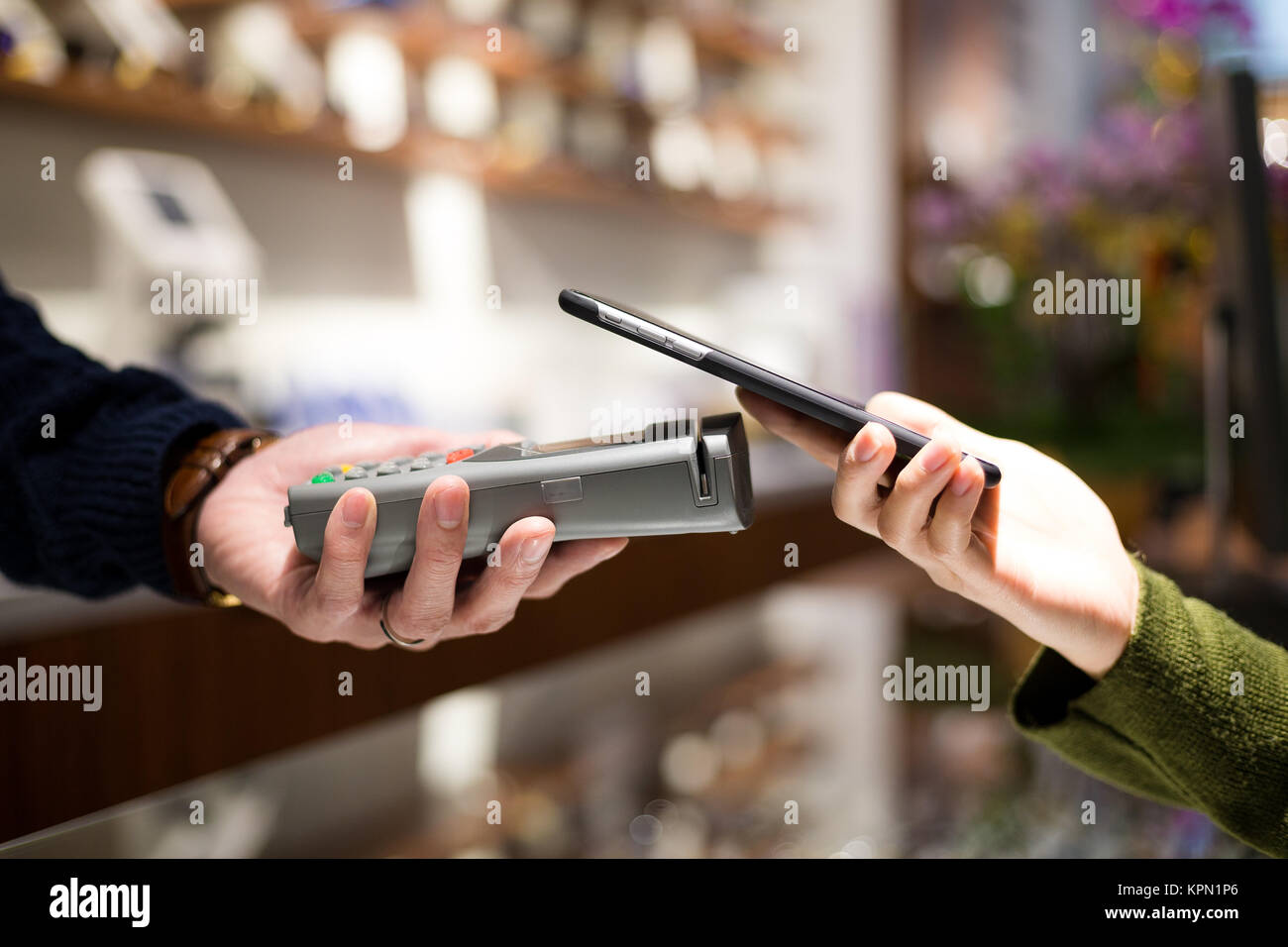 Woman pay by smart phone Stock Photo - Alamy