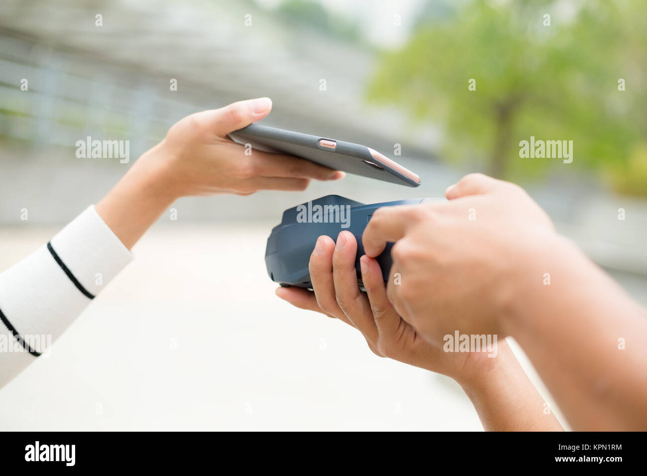 Woman use mobile phone on pos machine Stock Photo - Alamy