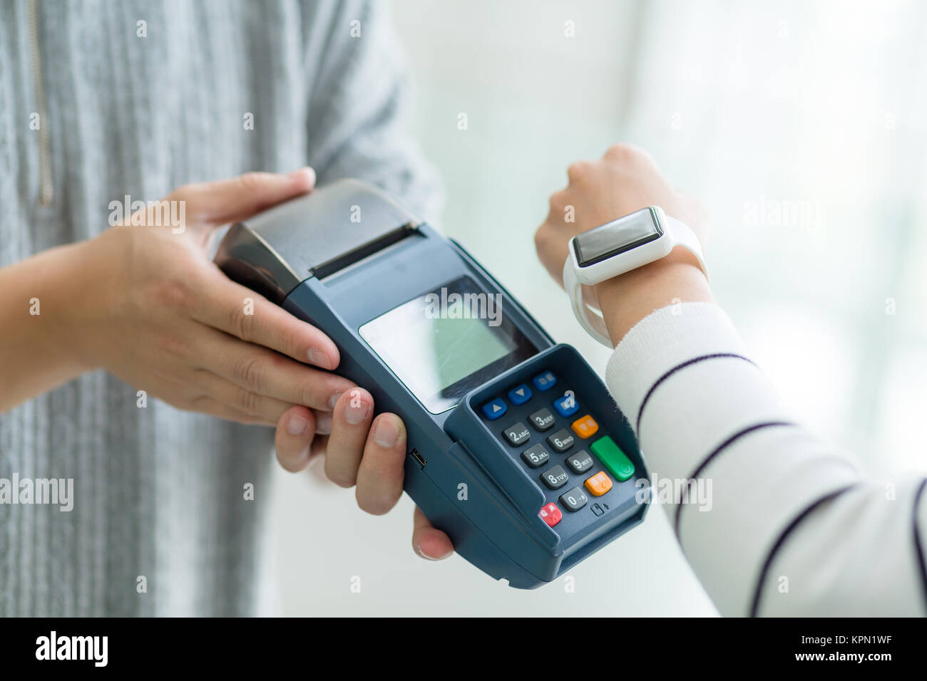 Woman using cellphone for paying the bill Stock Photo - Alamy