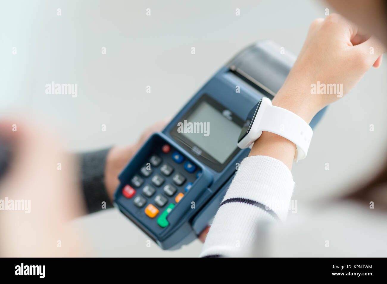 Woman using smart watch to pay Stock Photo - Alamy