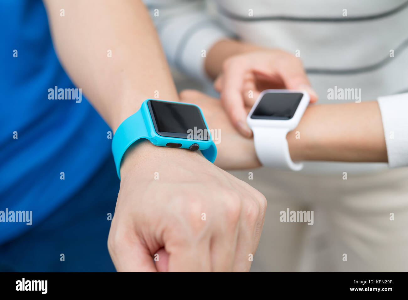 Two people using smart watch together Stock Photo - Alamy