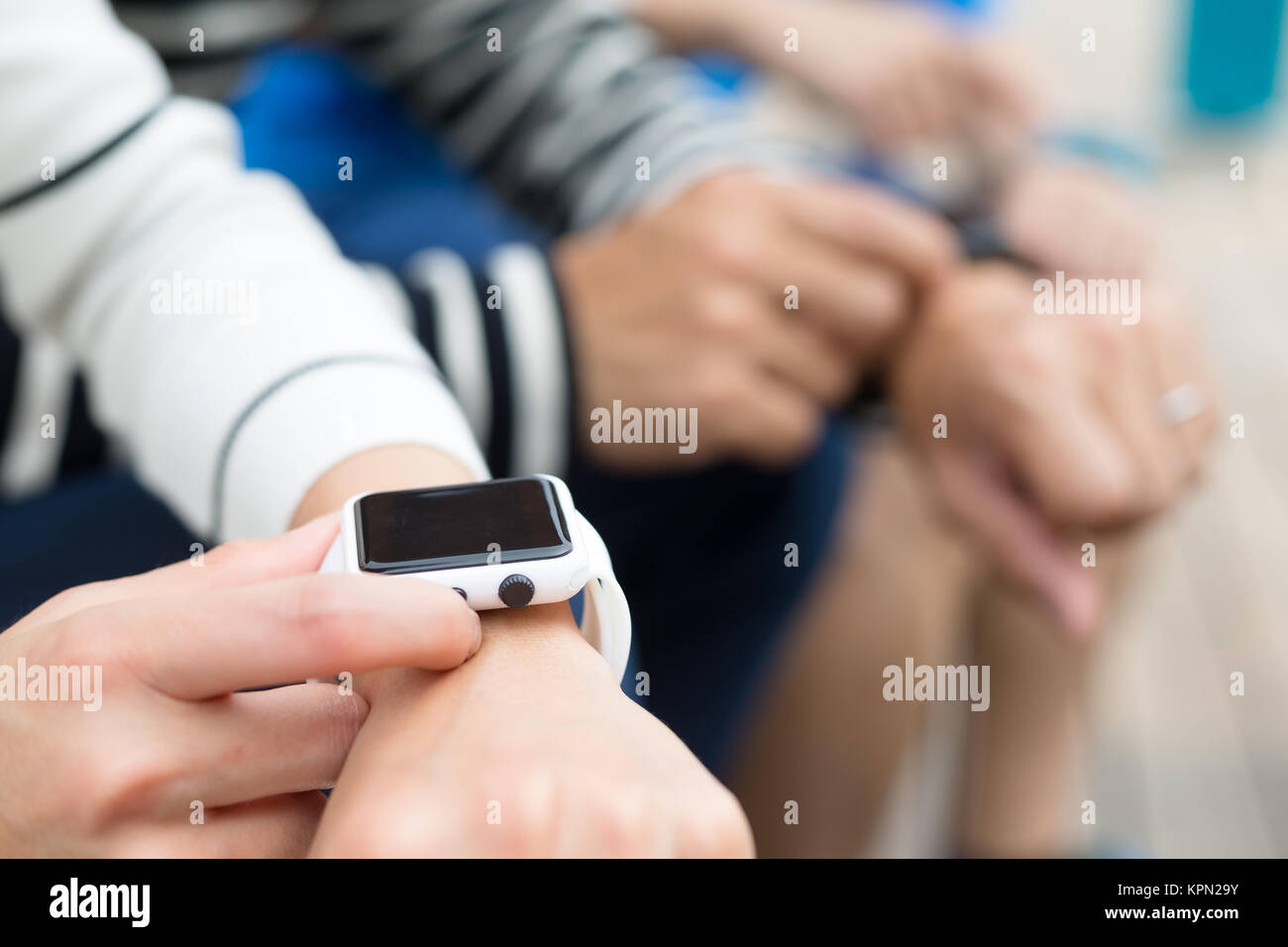 Group of people using smartwatch together Stock Photo - Alamy