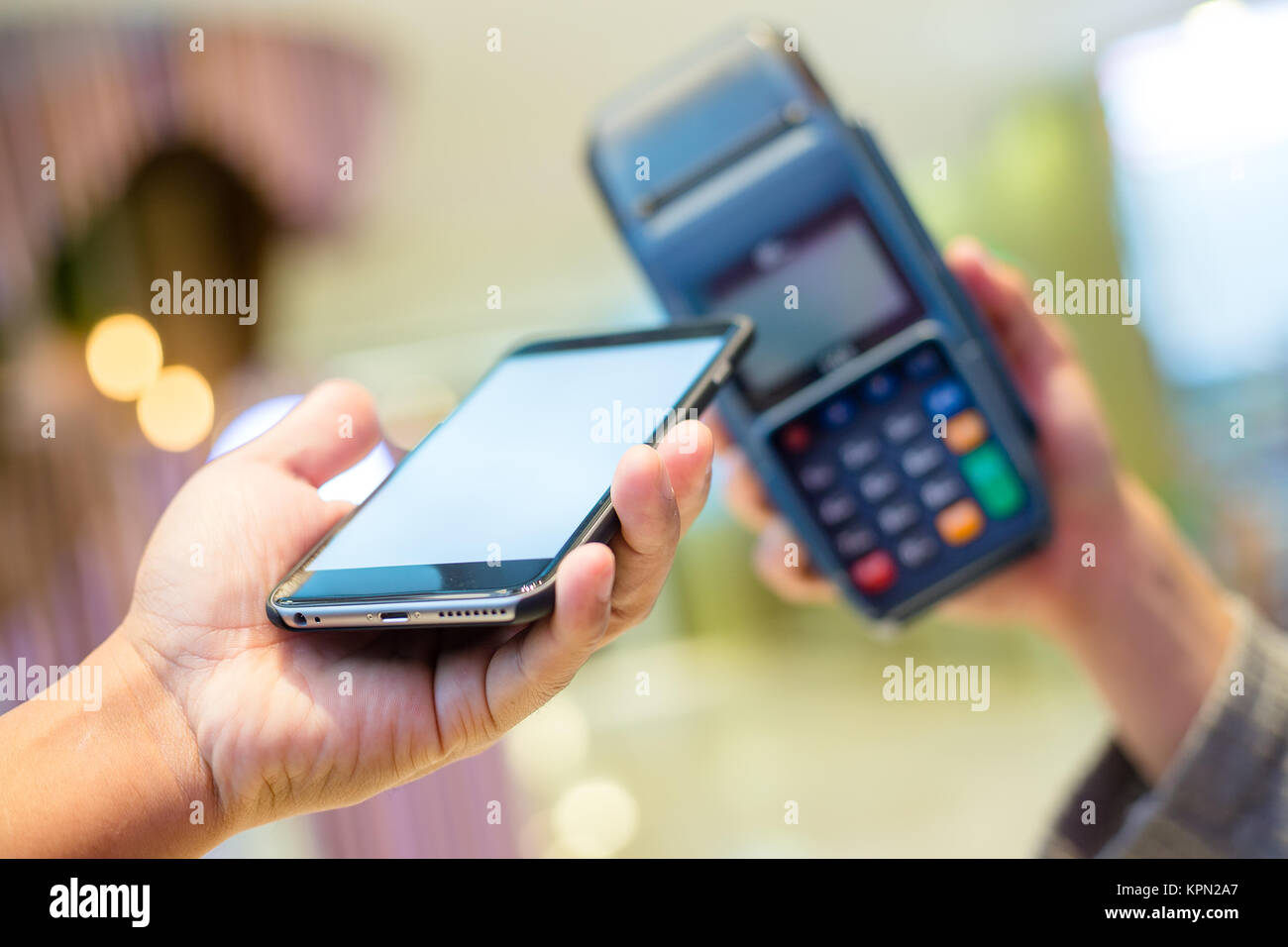 Customer using cellphone to pay Stock Photo - Alamy