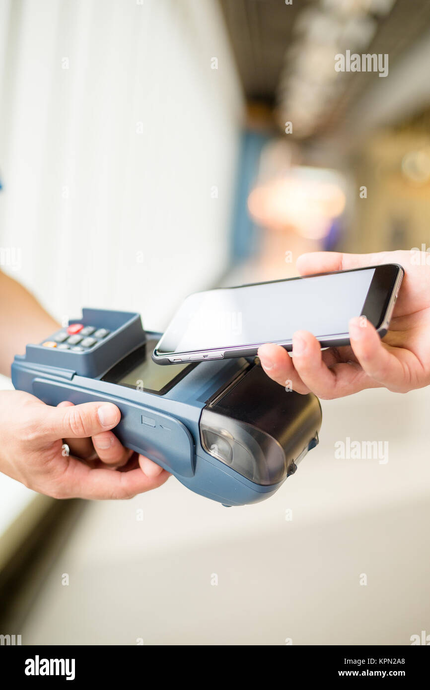 Customer pay by cellphone Stock Photo - Alamy