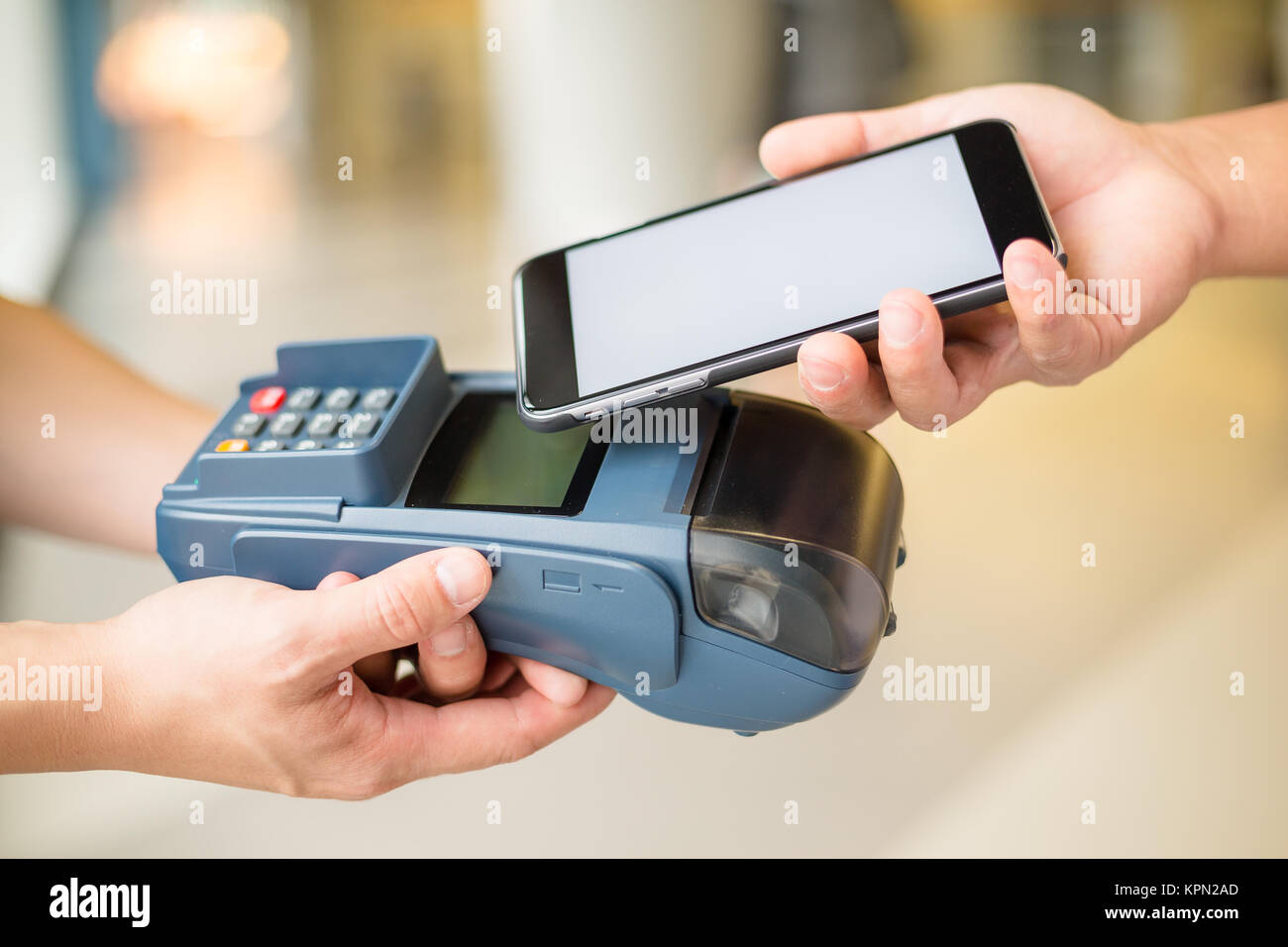 Woman pay by cellphone with NFC Stock Photo - Alamy