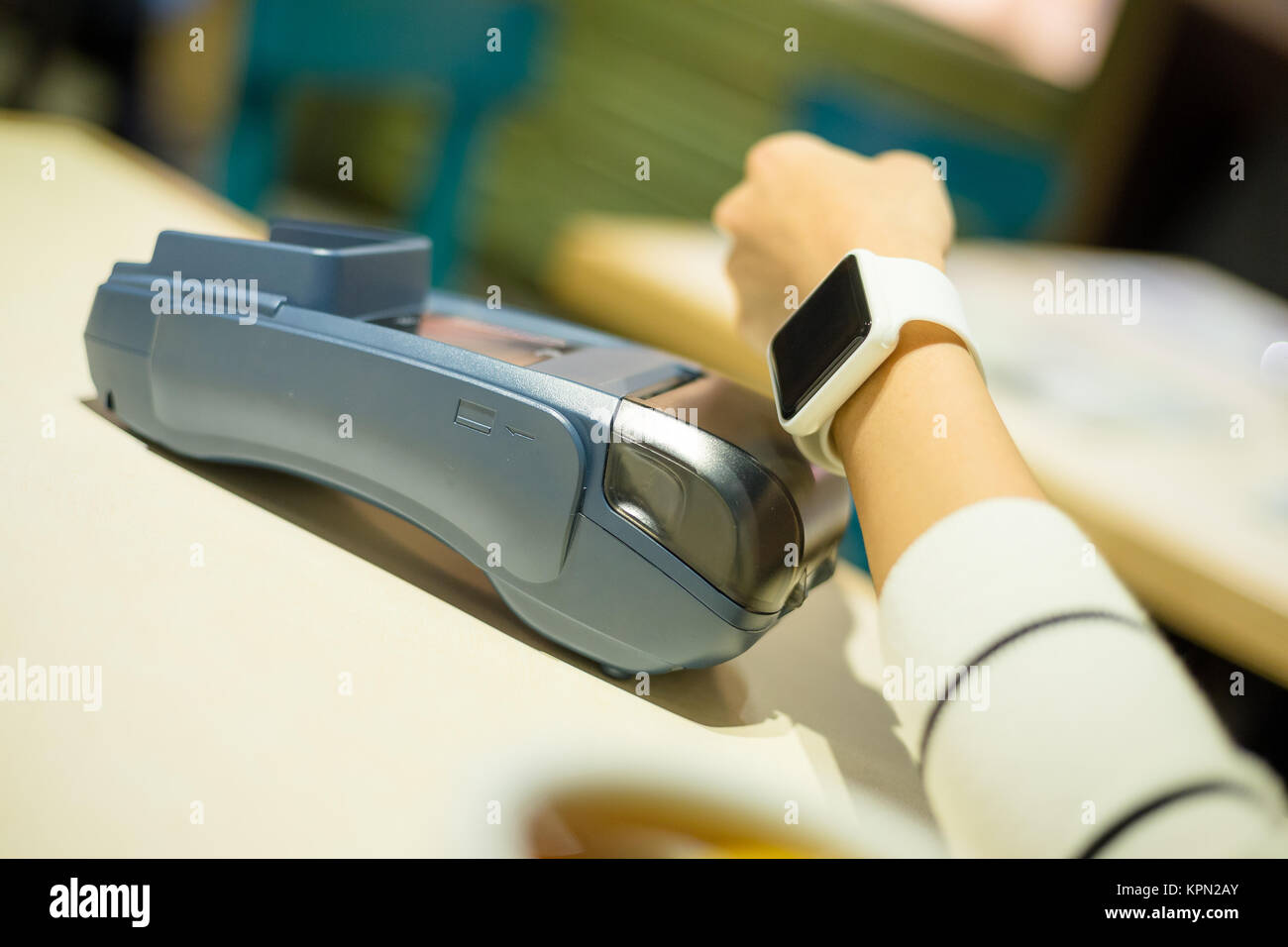 Customer using smart watch to pay Stock Photo - Alamy