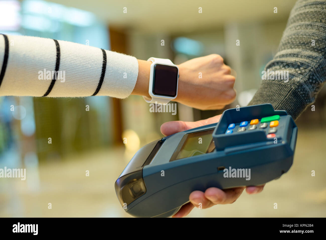 Customer using smart watch to pay by NFC technology Stock Photo - Alamy