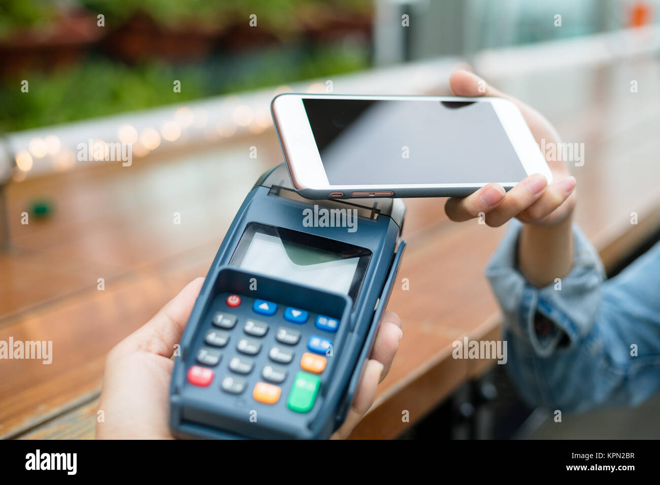 Woman use of mobile phone to pay Stock Photo - Alamy