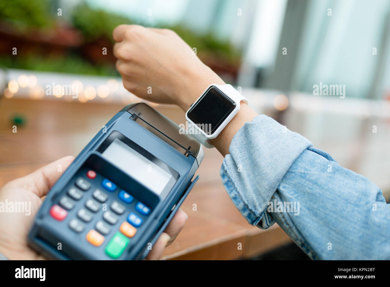 Woman pay by smart watch with NFC technology Stock Photo - Alamy