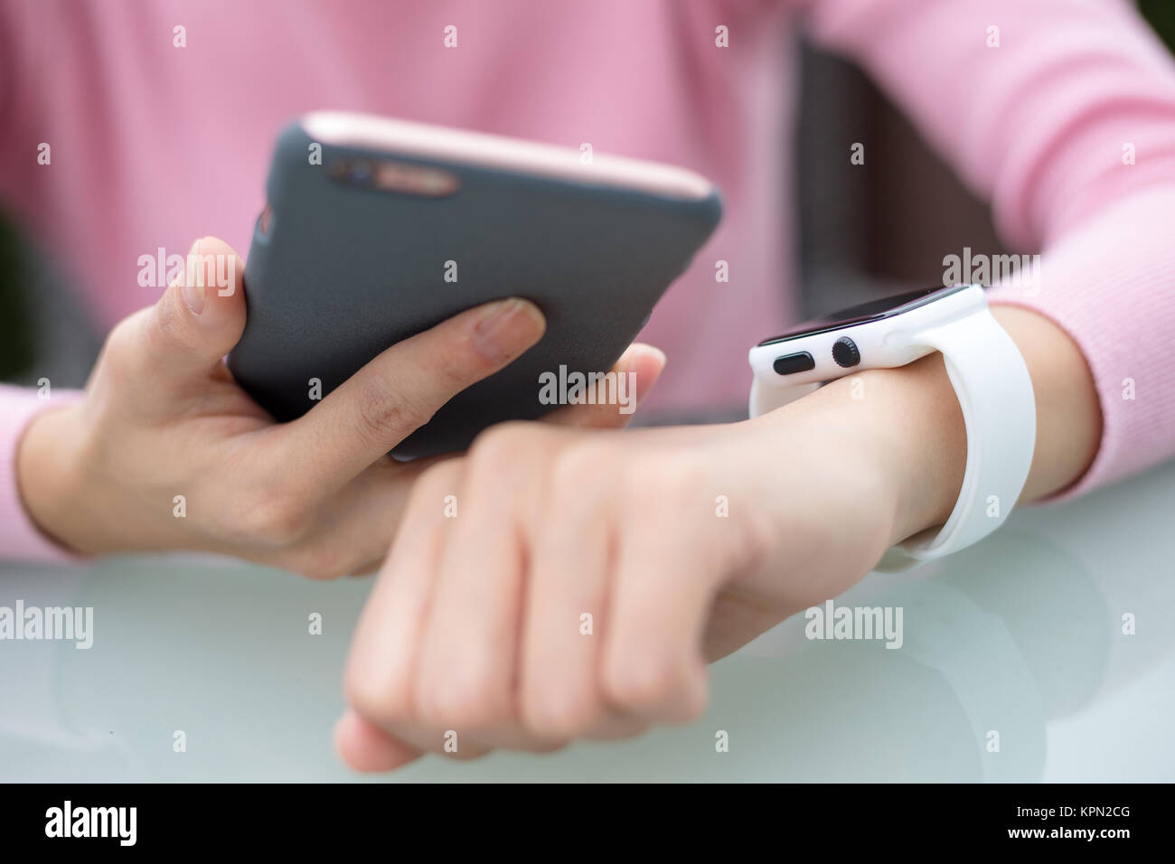 Woman connect with cellphone and smartwatch Stock Photo - Alamy
