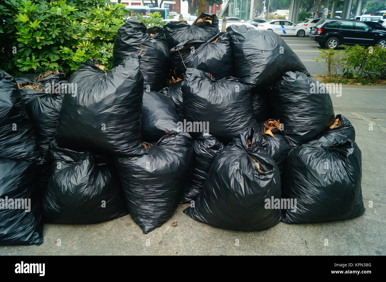 Black plastic bags filled with garbage, heaps of heaps, on the city ...