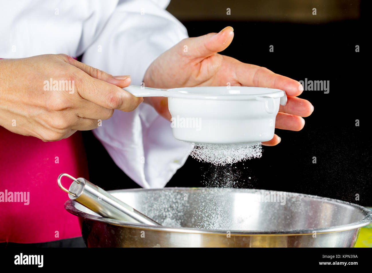 Sieving flour into mixing bowl hi-res stock photography and images - Alamy