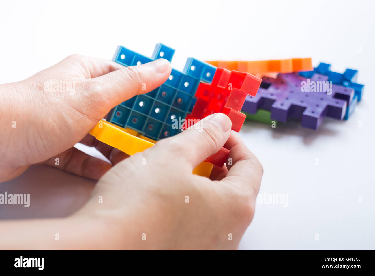 Hand on jigsaw puzzle game Stock Photo - Alamy