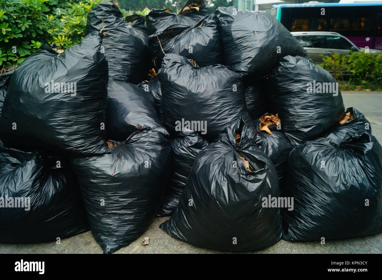 Black plastic bags filled with garbage, heaps of heaps, on the city ...