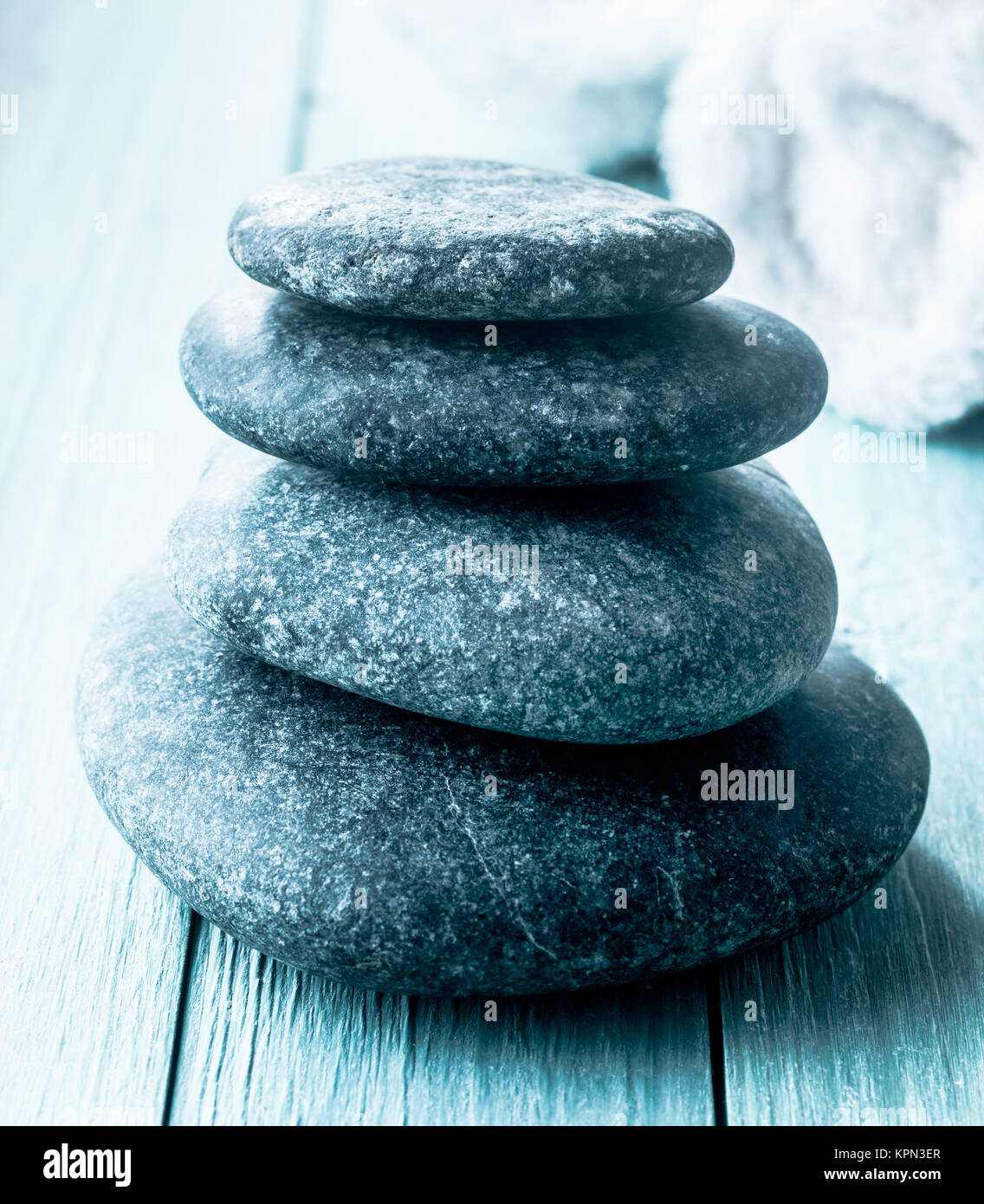 Stack of smooth spa stones for a hot rock massage treatment on rustic ...
