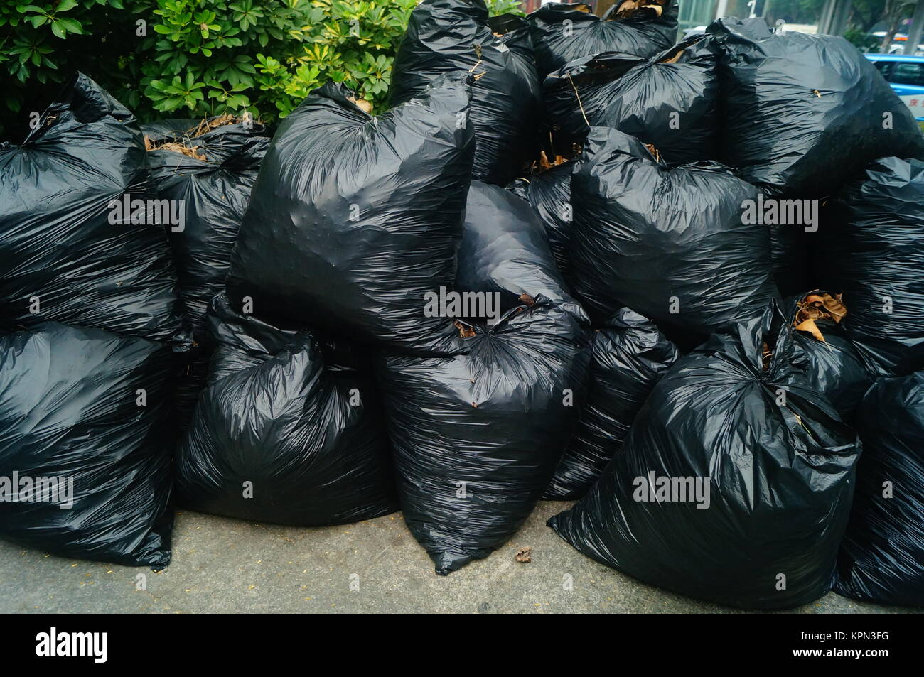 Black plastic bags filled with garbage, heaps of heaps, on the city ...