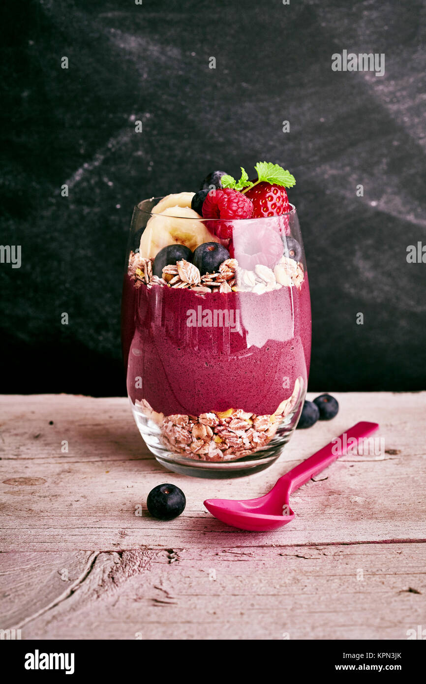 Deliciously sweet acai fruit dessert with pieces of banana, strawberry ...