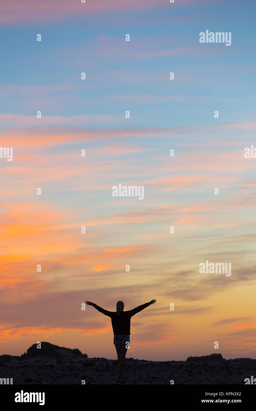 Woman enjoying freedom at sunset Stock Photo - Alamy