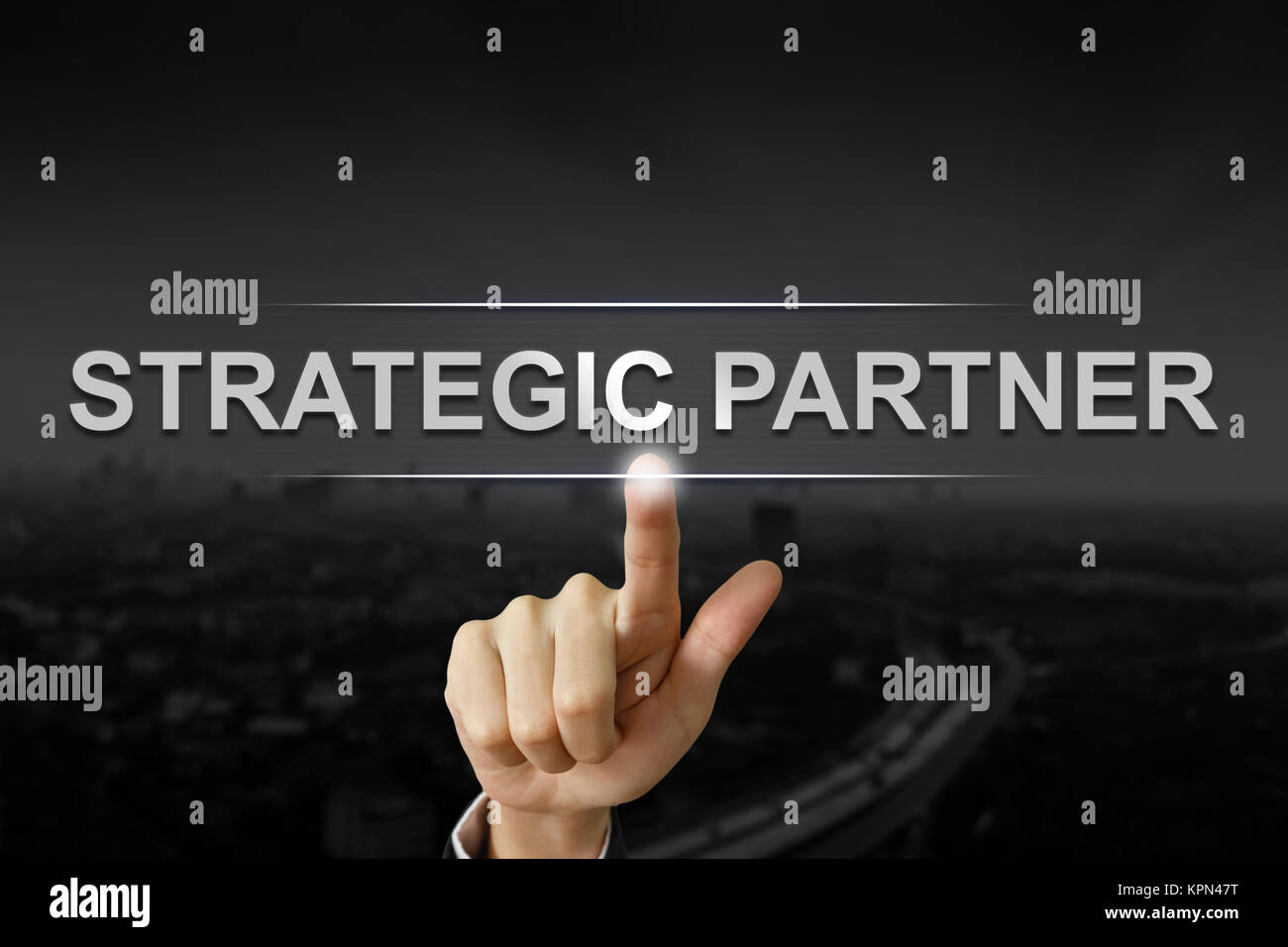 business hand pushing strategic partner button on black blurred ...