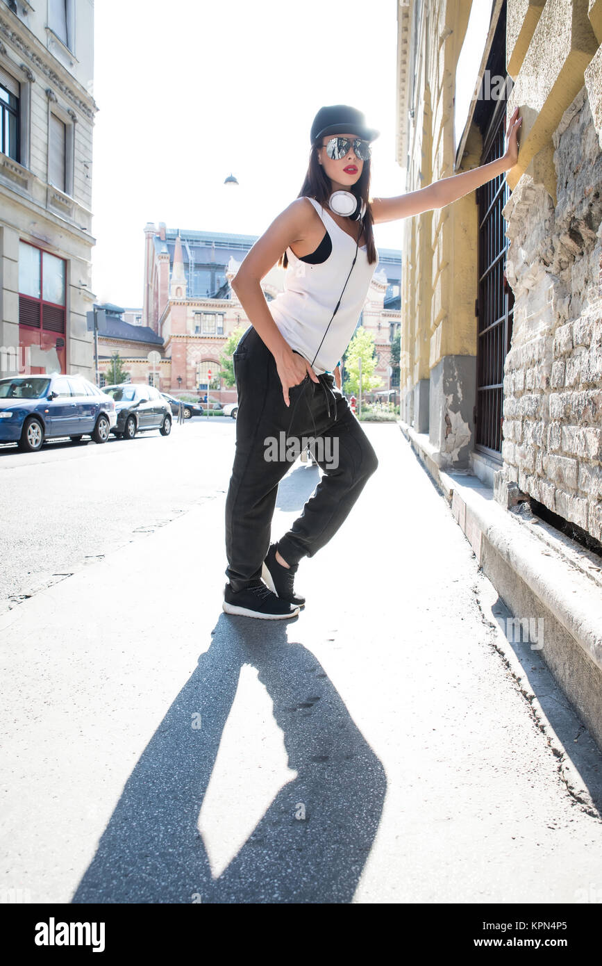 A beautiful young Hip Hop Rapper girl with Headphones in a urban ...