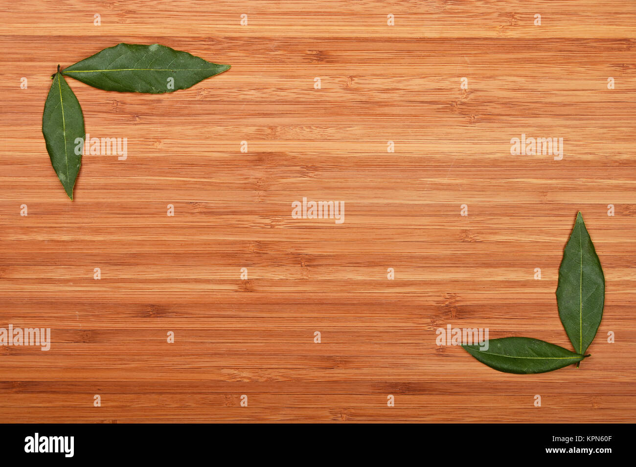 Bay leaves frame corners over bamboo wood Stock Photo - Alamy