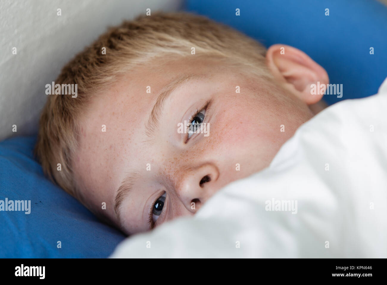 Cute boy waking up Stock Photo - Alamy