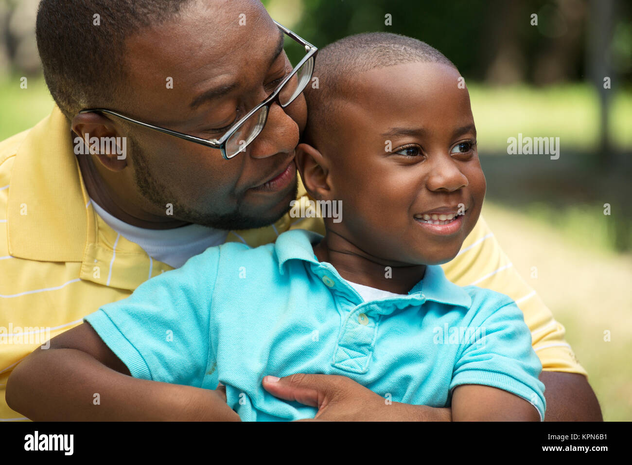 Father hugging his his son Stock Photo - Alamy