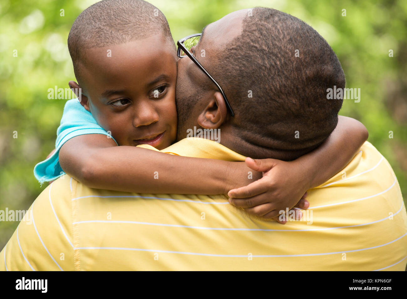 Father hugging his his son Stock Photo - Alamy
