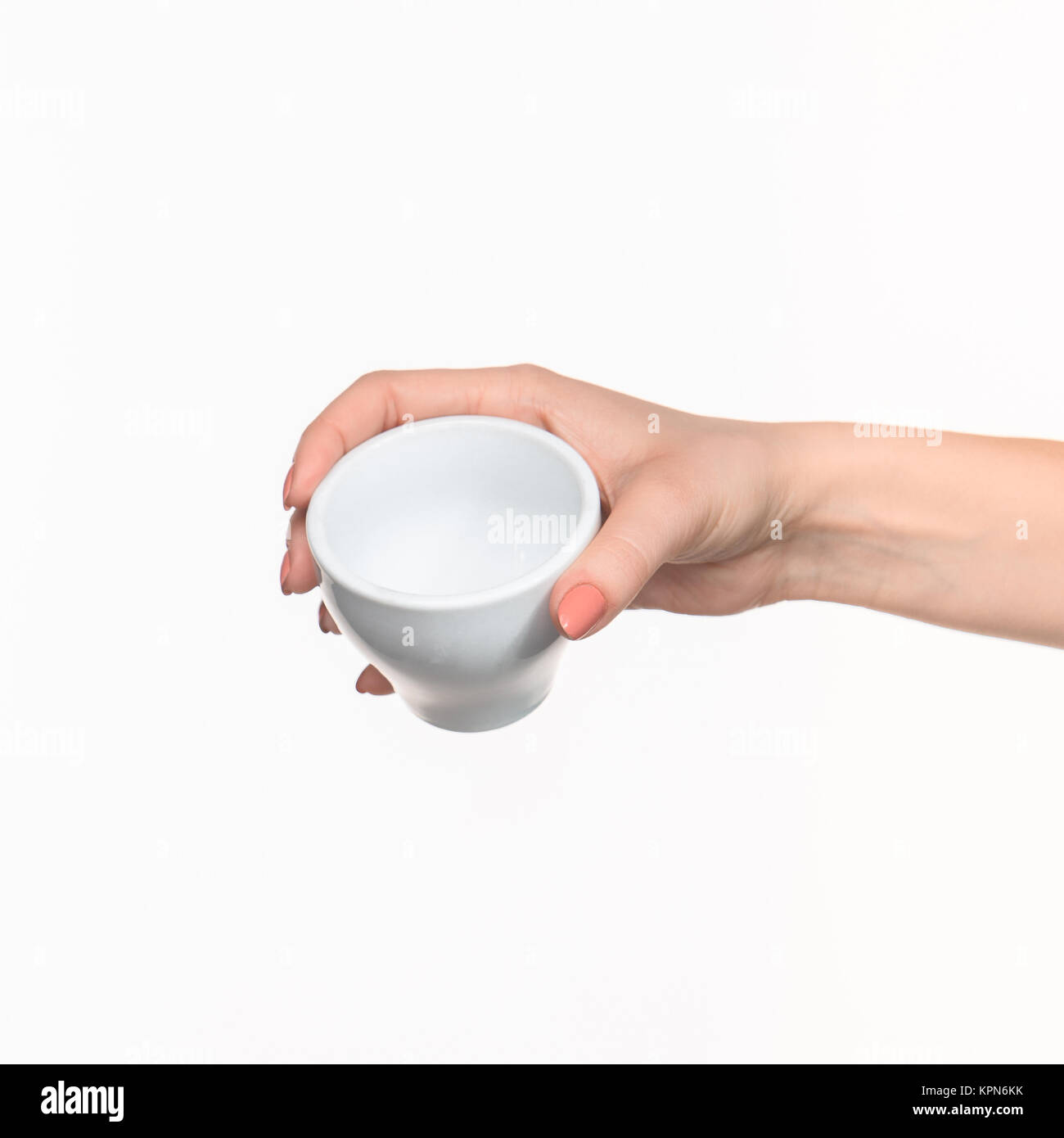 Woman hand with cup on white background Stock Photo - Alamy