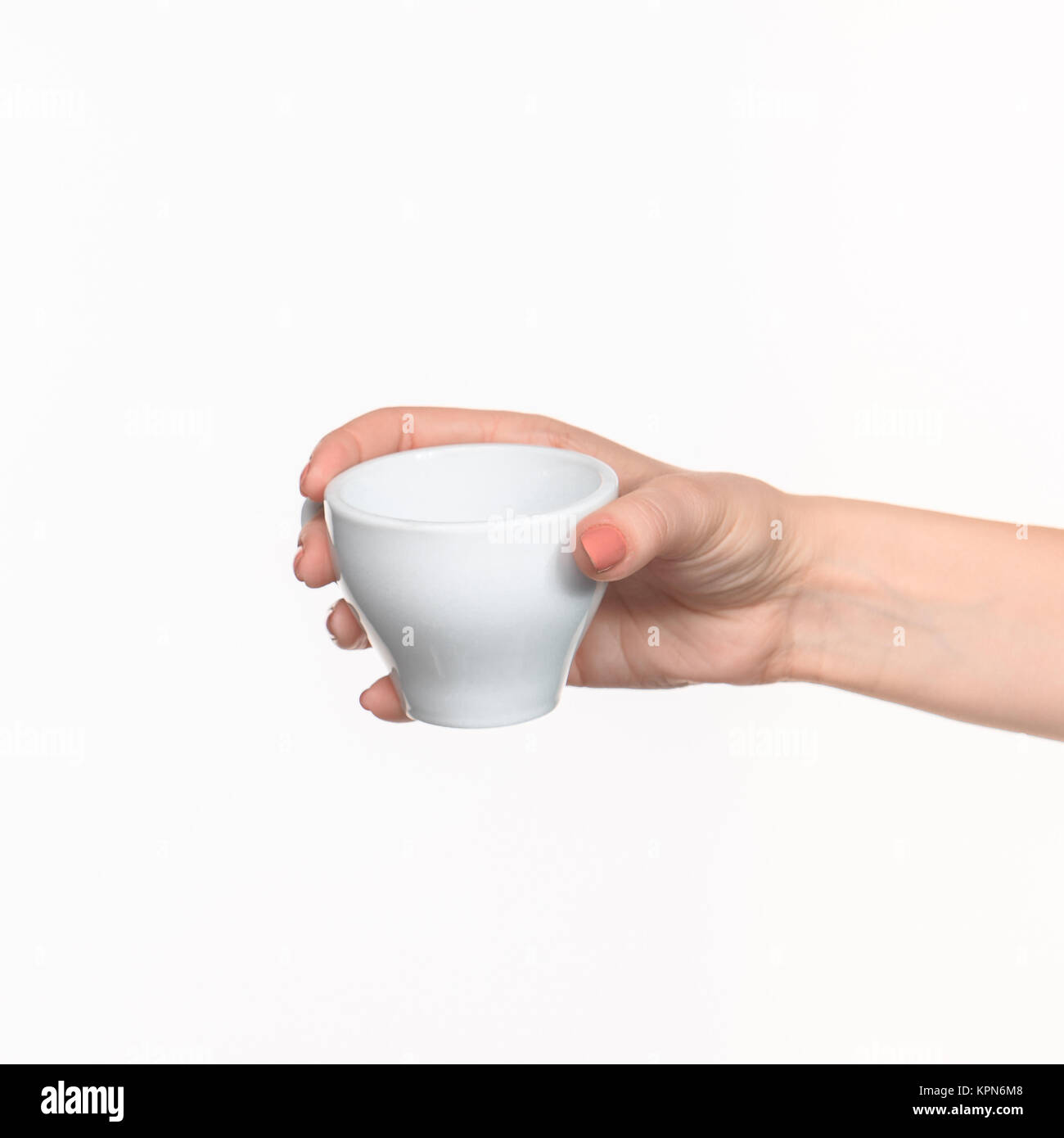 Woman hand with cup on white background Stock Photo - Alamy