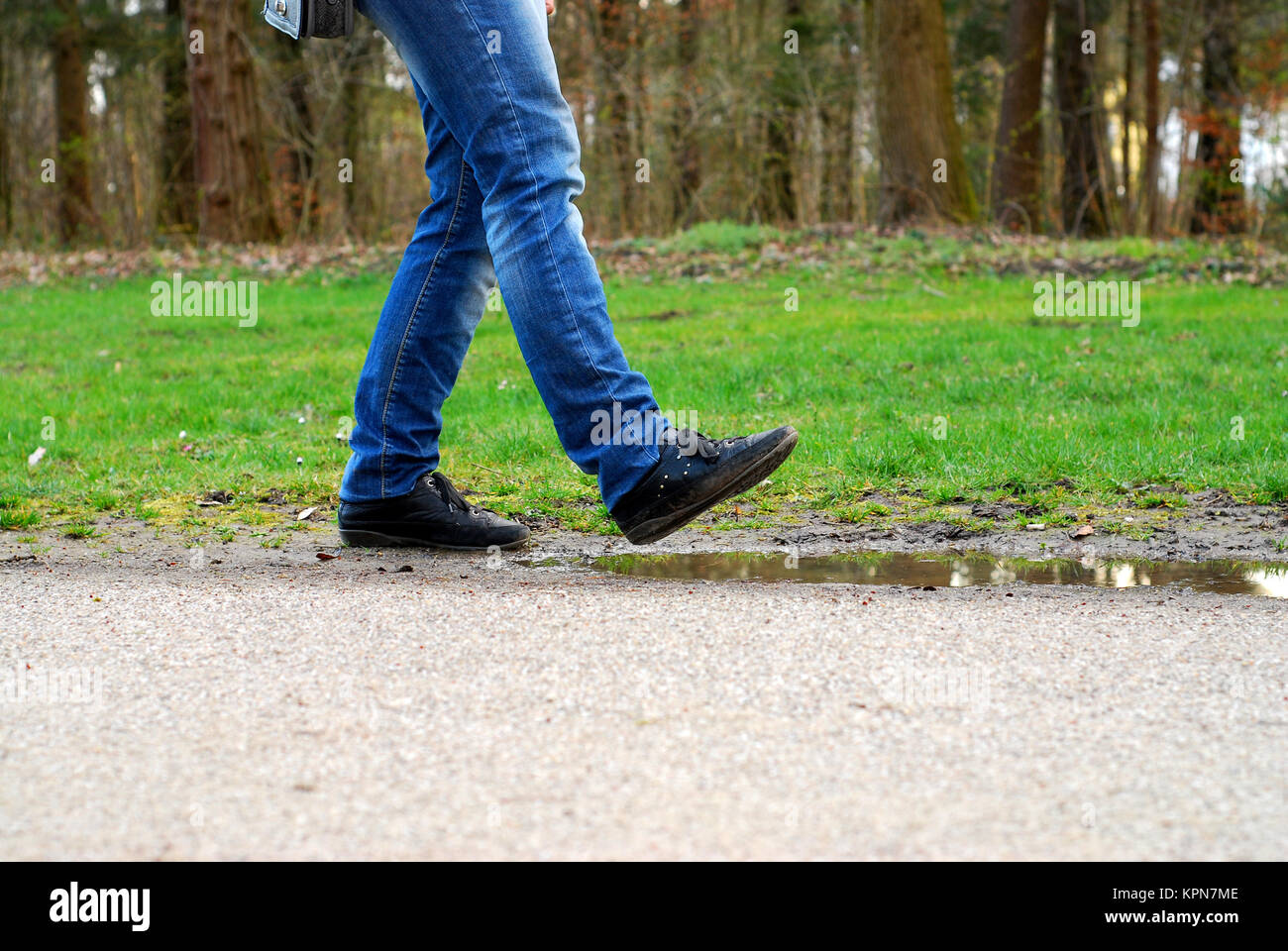 woman walks and occurs equally in a puddle Stock Photo - Alamy