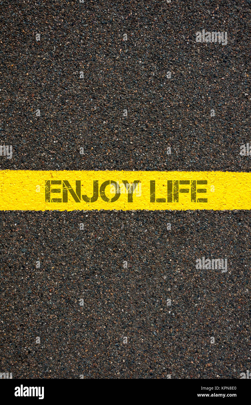 Road marking yellow line with words ENJOY LIFE Stock Photo - Alamy