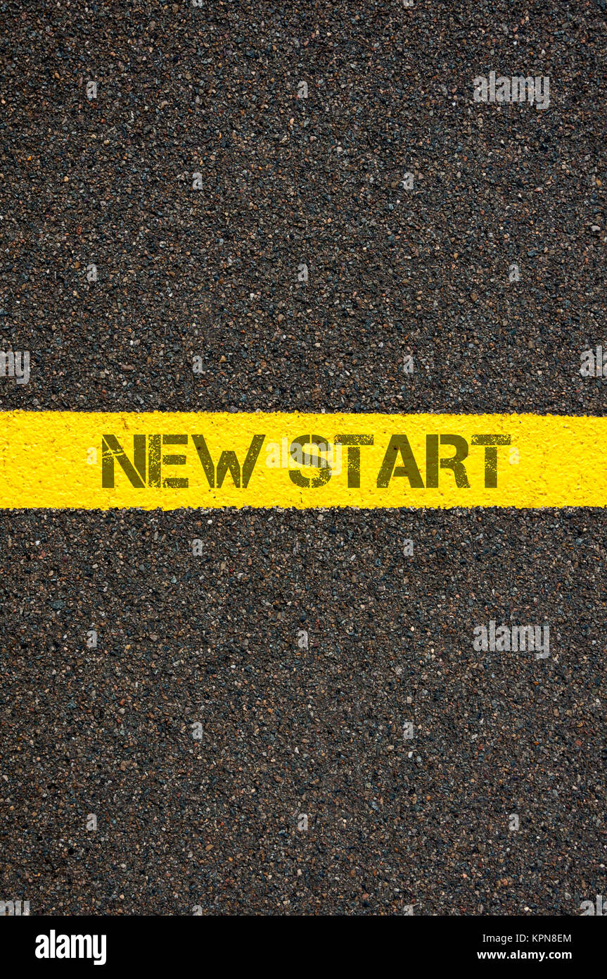 Road marking yellow line with words NEW START Stock Photo - Alamy