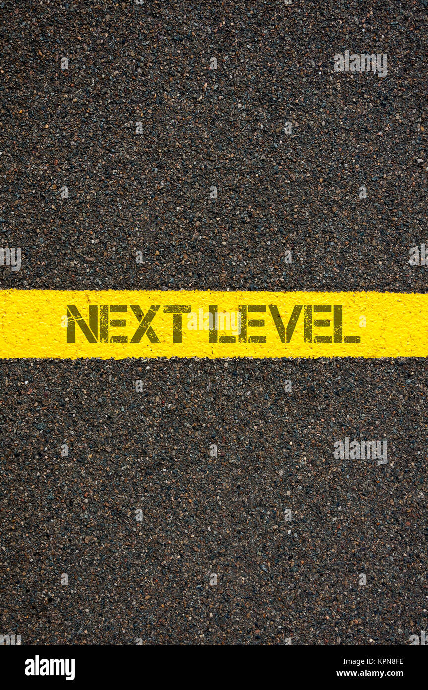 Road marking yellow line with words NEXT LEVEL Stock Photo - Alamy