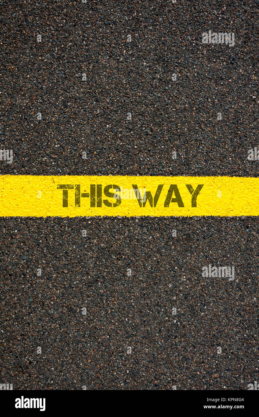 Road marking yellow line with text THIS WAY Stock Photo - Alamy
