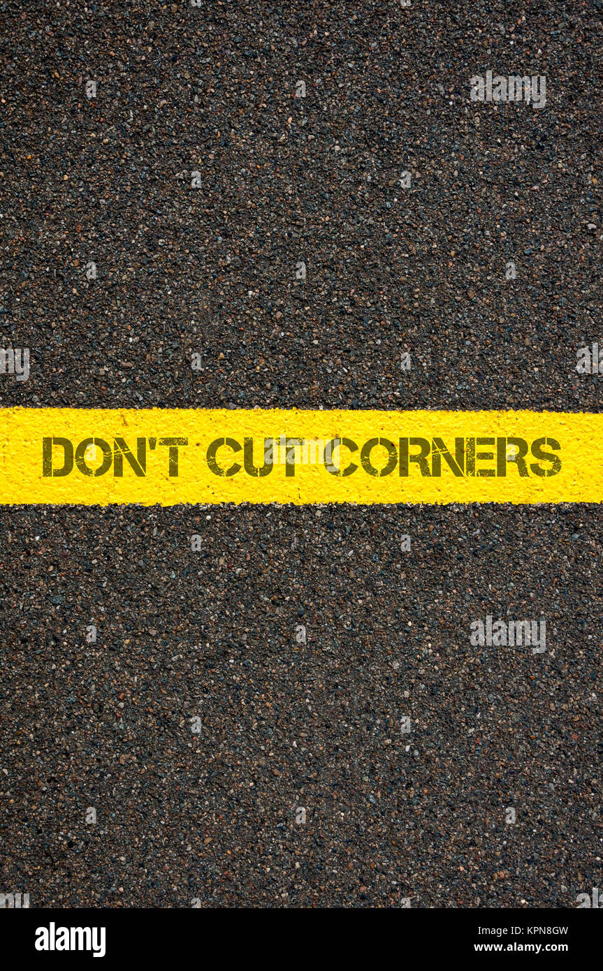 Road marking yellow line words DON' T CUT CORNERS Stock Photo - Alamy