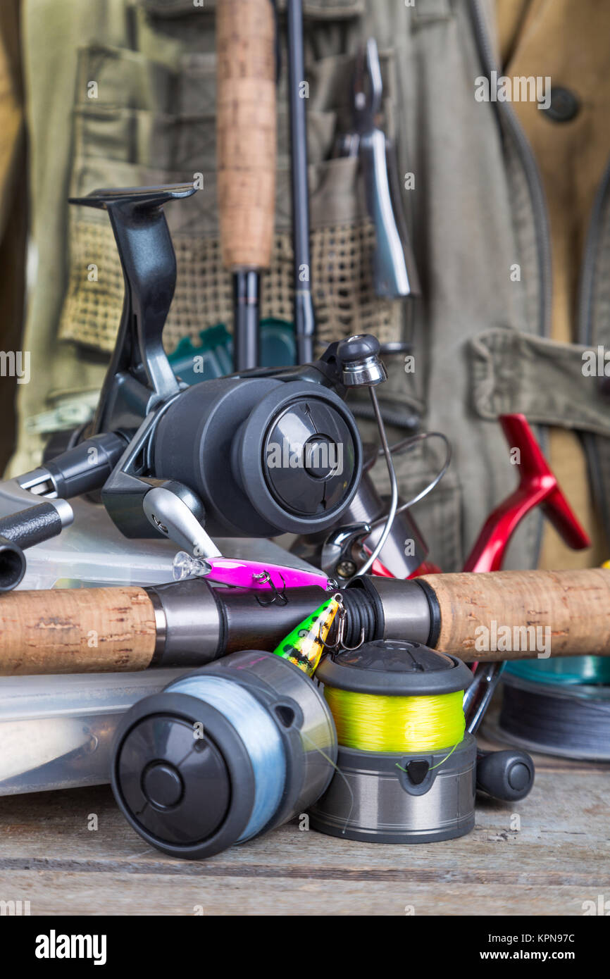 fishing tackles with fishing vest and boots Stock Photo - Alamy