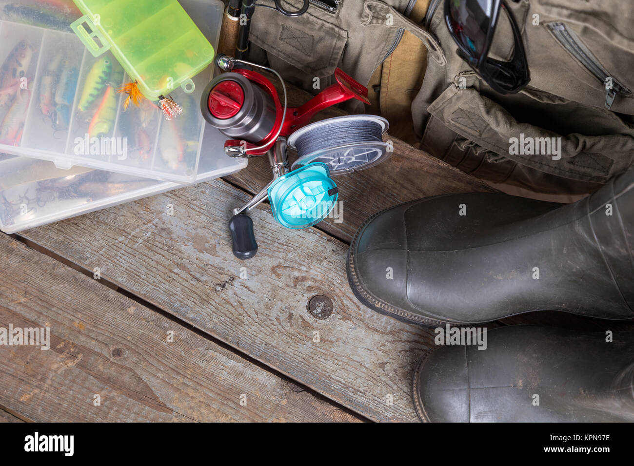 fishing tackles with fishing vest and boots Stock Photo - Alamy