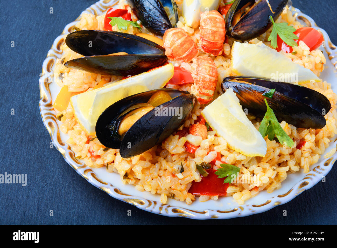 vegetable paella with seafood from rice, mussels and lemon Stock Photo ...