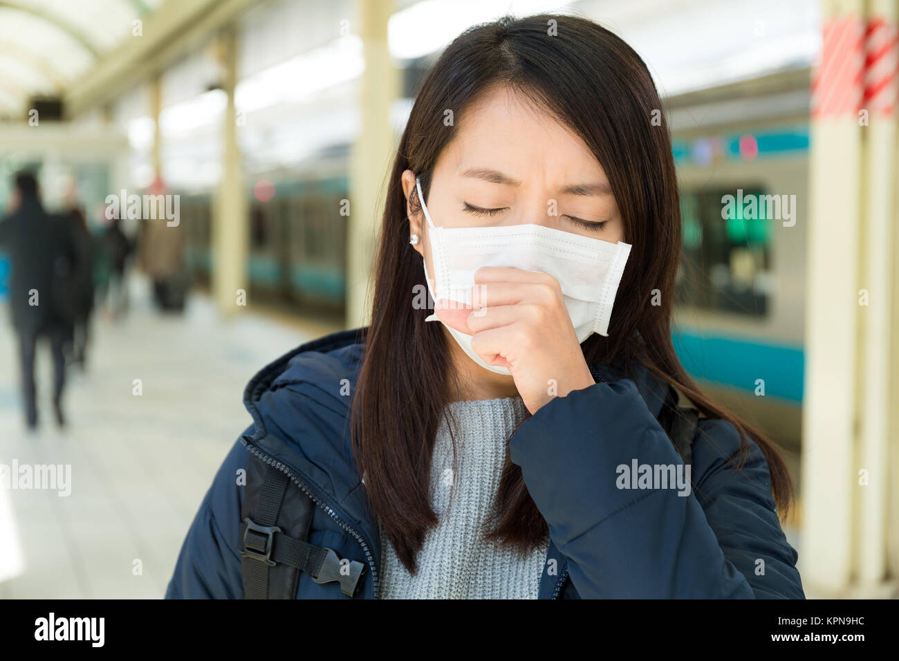 Woman wearing face mask at train platform Stock Photo - Alamy