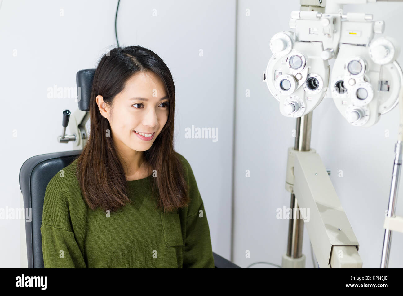 Woman ready to do the eye test Stock Photo - Alamy