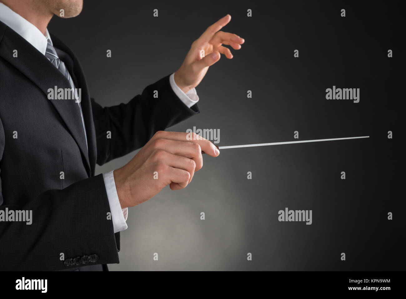 Person Directing With A Conductor's Baton Stock Photo - Alamy