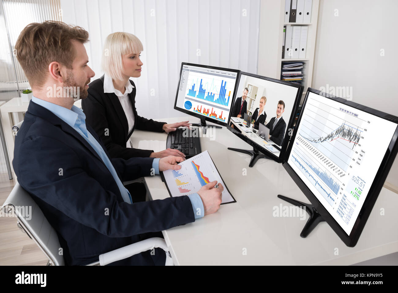 Businesspeople Working With Multiple Computer Stock Photo - Alamy