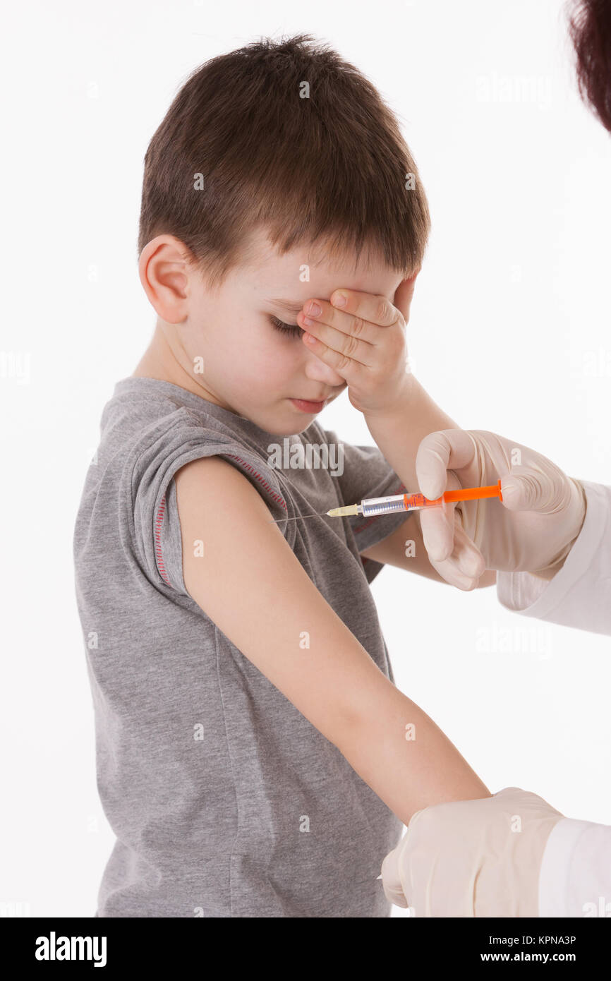 Doctor giving a child injection in arm on isolated image Stock Photo ...