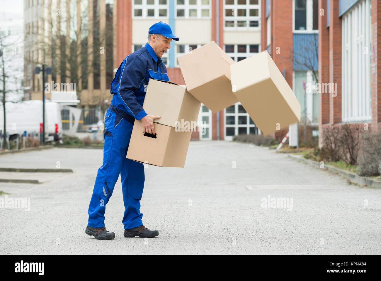 Delivery man falling stack boxes hi-res stock photography and images ...