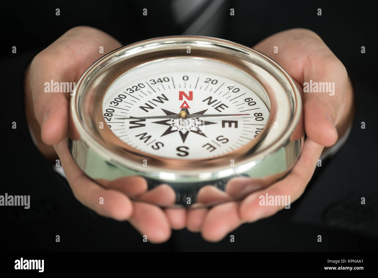 Businessman Hand Holding Compass Stock Photo - Alamy