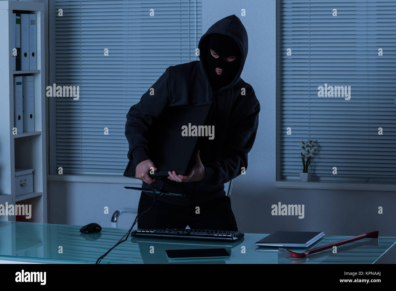 Thief Stealing Computer Stock Photo - Alamy