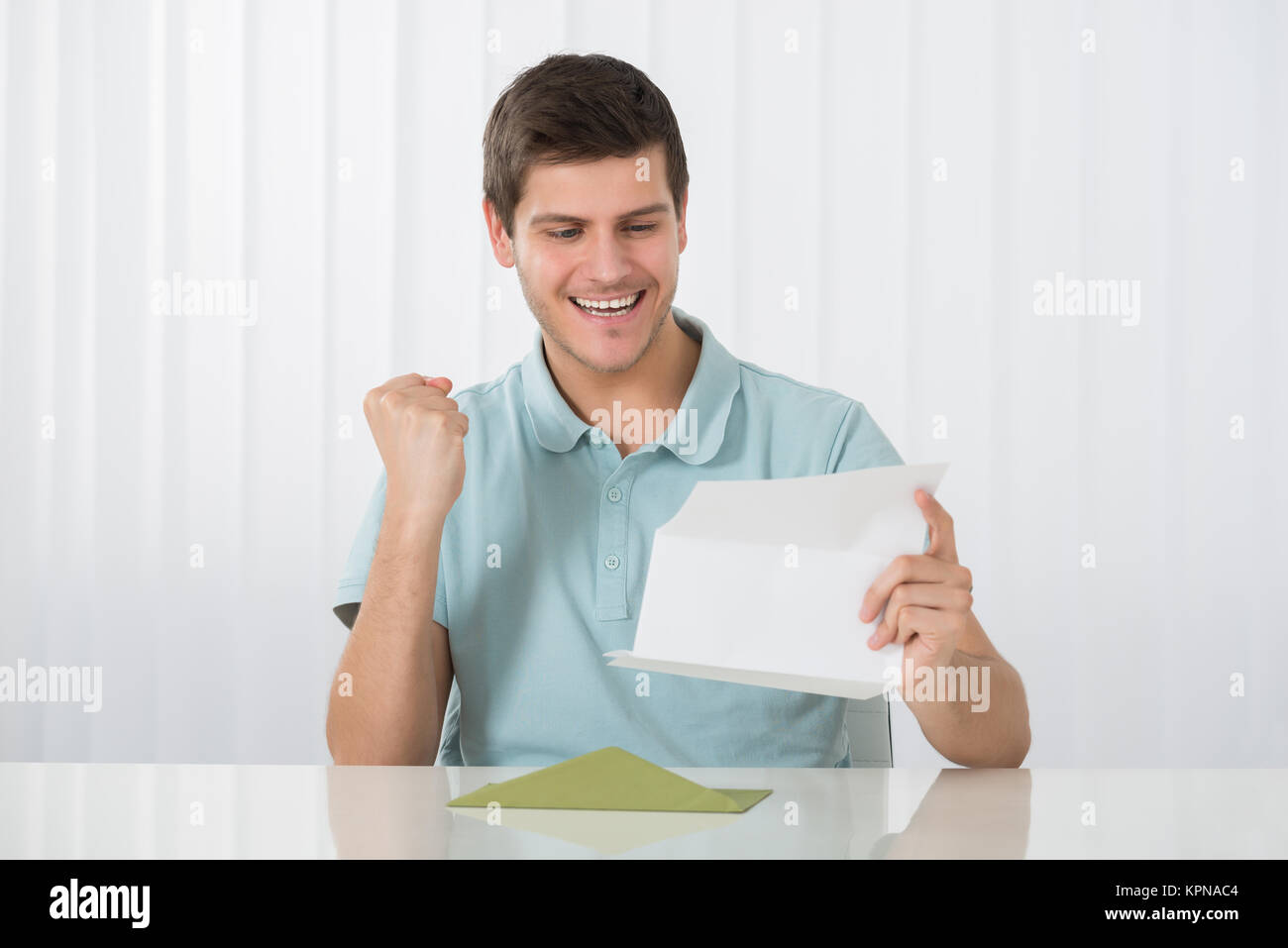 Happy Man Holding Letter On Desk Stock Photo - Alamy