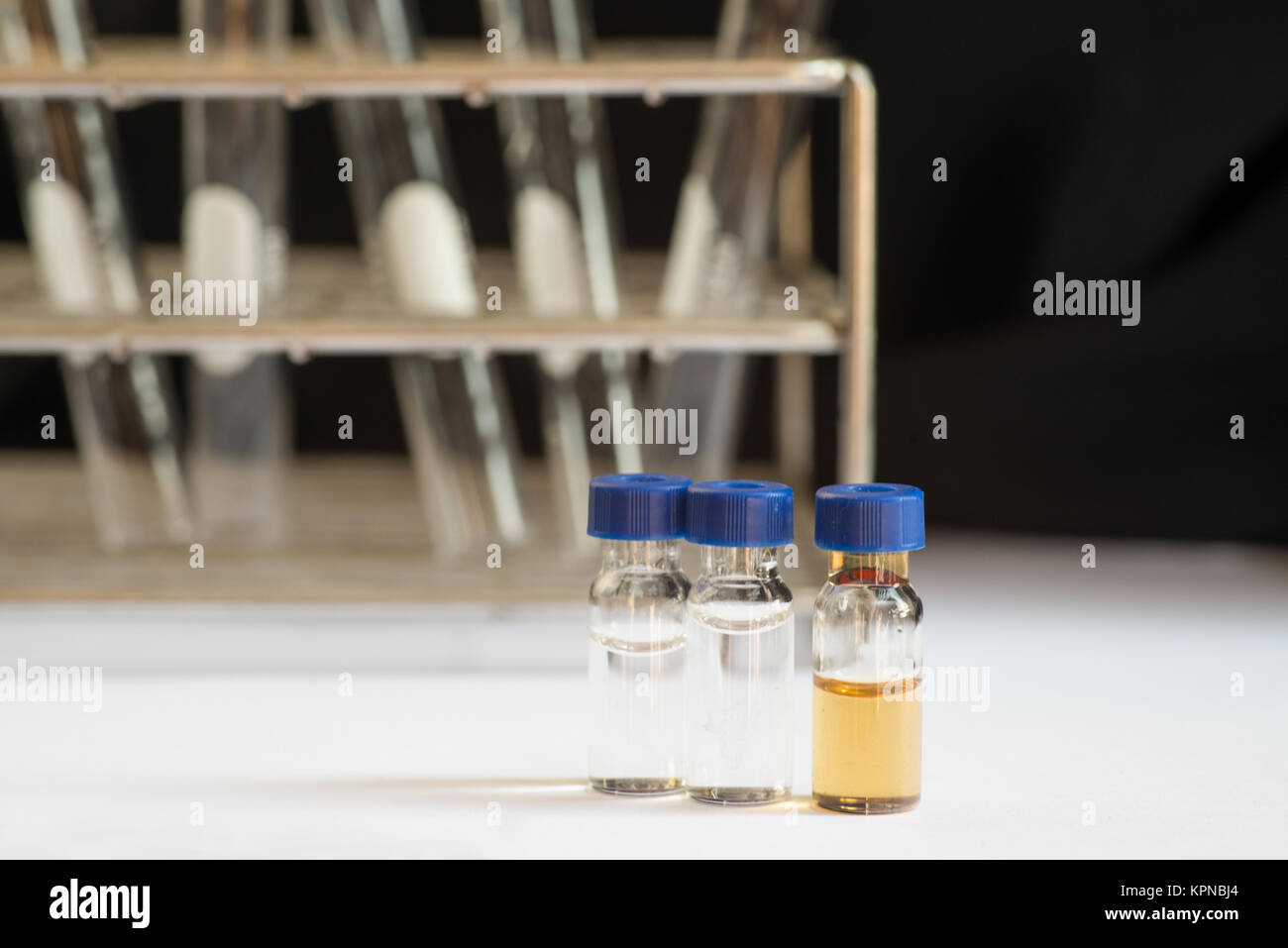 Blue cap vial in front of Laboratory glassware Stock Photo - Alamy