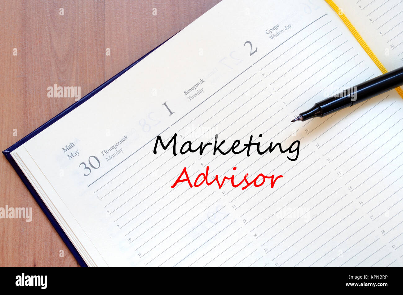 Marketing advisor write on notebook Stock Photo - Alamy